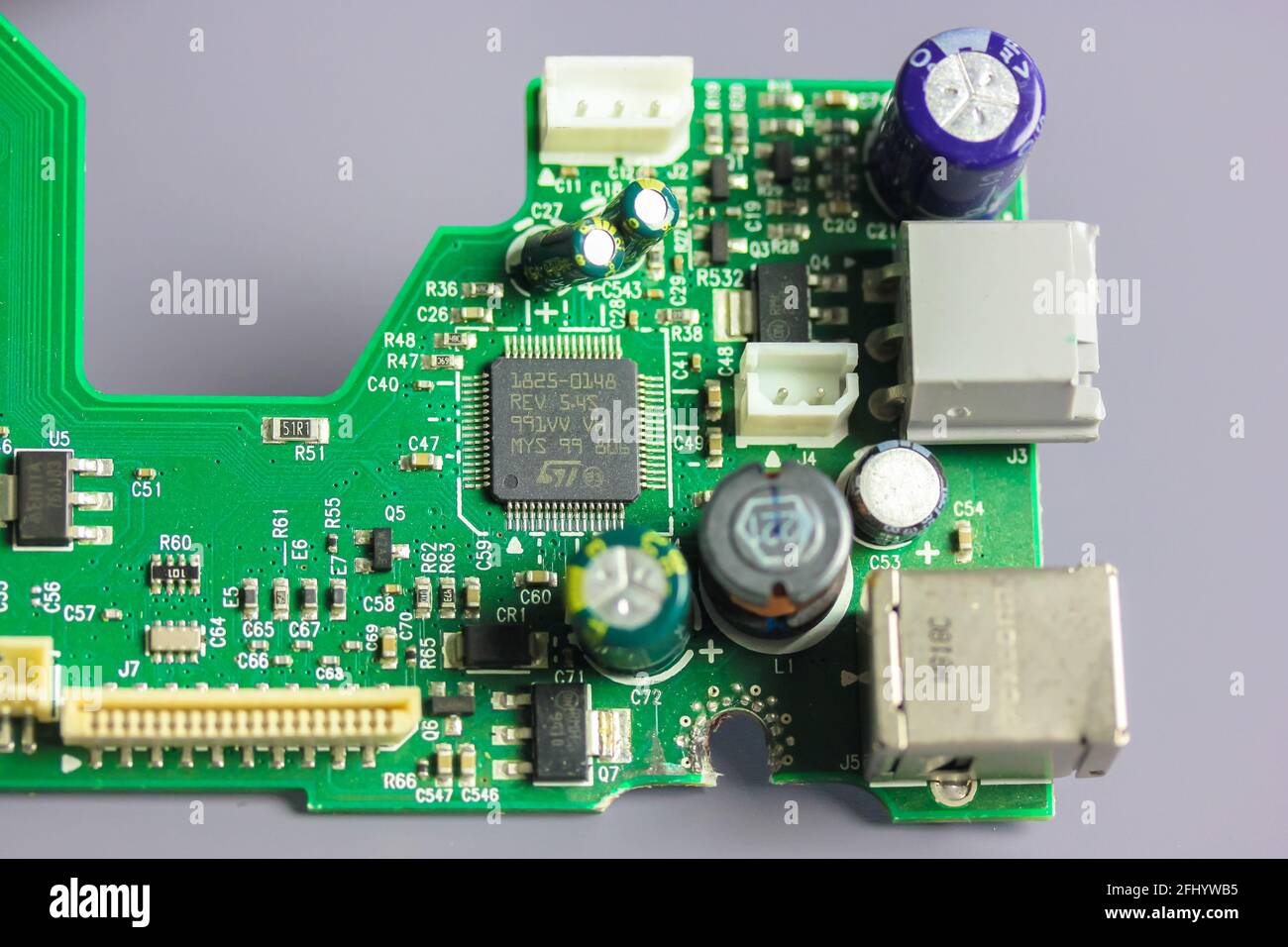 A green electronic circuit board flatly. Top view of pcb board circuit ...
