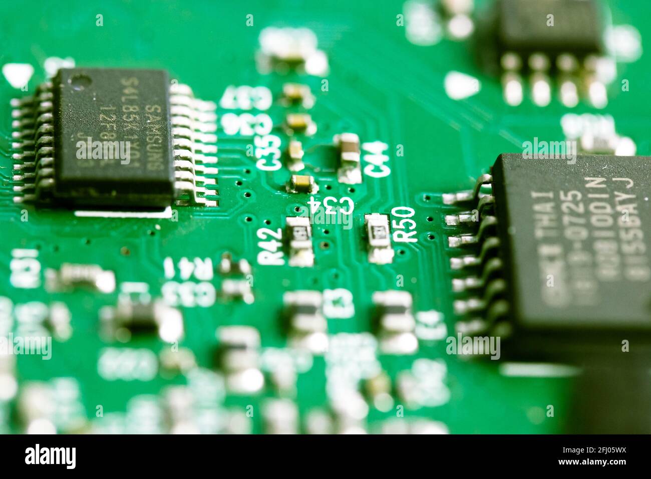 A green electronic circuit board flatly. Top view of pcb board circuit ...
