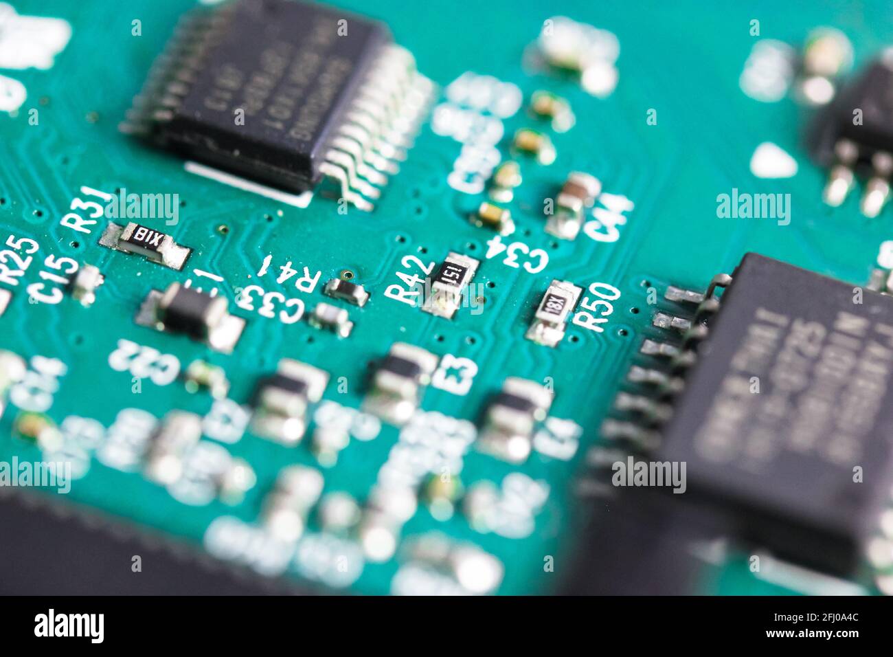 A green electronic circuit board flatly. Top view of pcb board circuit ...