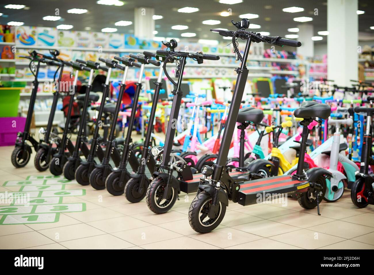 Sale of scooters and bicycles in a children's store Stock Photo - Alamy