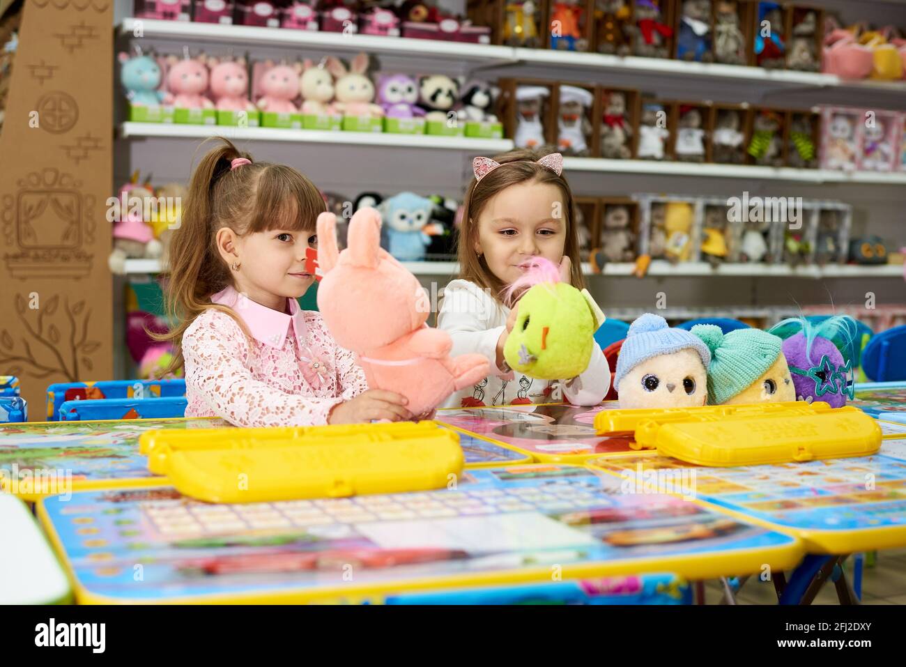 Little happy girls in a toy store Stock Photo - Alamy