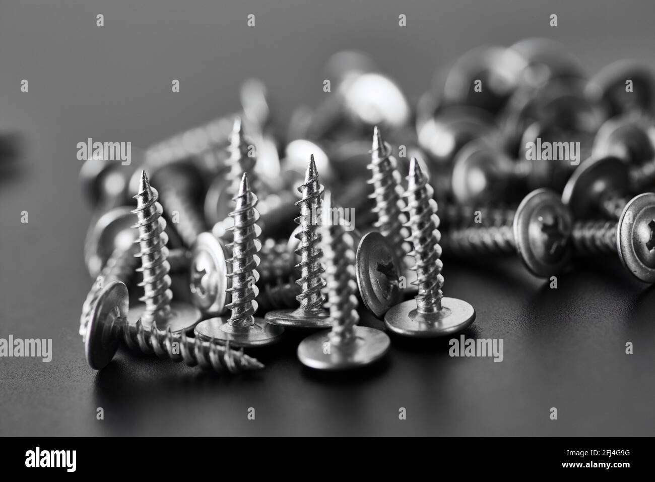 Stack of self-tapping screws, grey background Stock Photo - Alamy