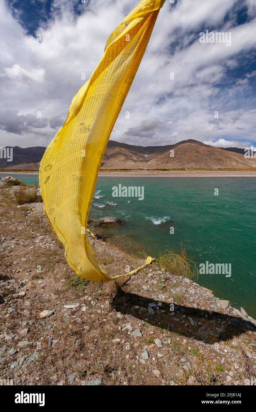 Buddhist Prayer Flag on the riverbank of the Brahmaputra River in Tibet ...