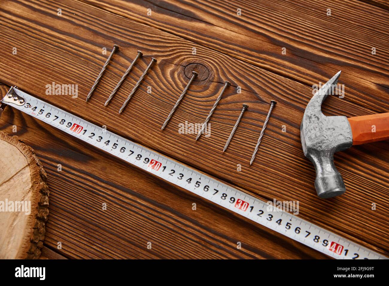 Screw nails, hammer and measuring tape Stock Photo - Alamy