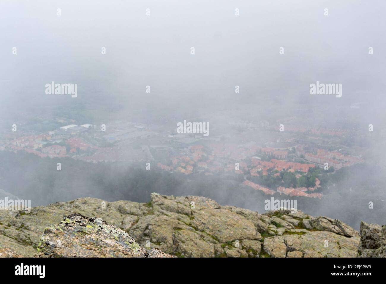 Views of El Escorial from the mountain on a day of heavy fog, with ...
