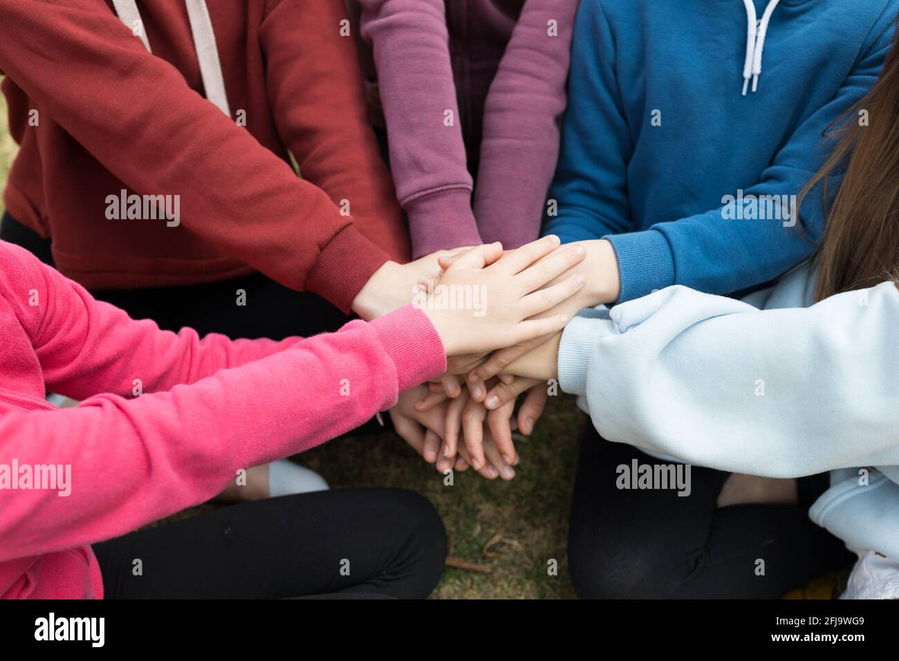 Stack of hands - young girls agreement Stock Photo - Alamy