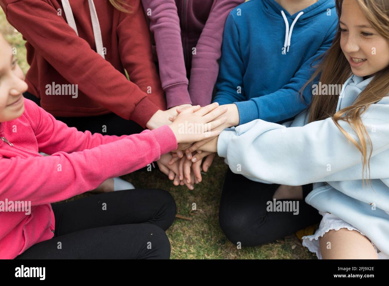 Stack of hands - young girls agreement Stock Photo - Alamy