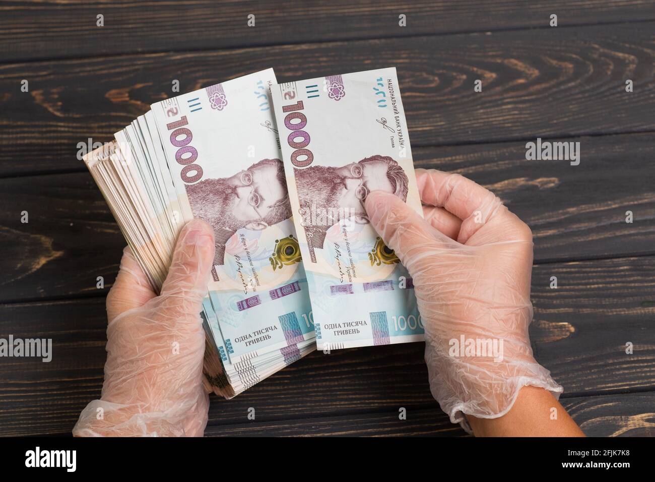 Money of Ukraine. Stack of ukrainian hryvnia banknotes in gloved hands ...