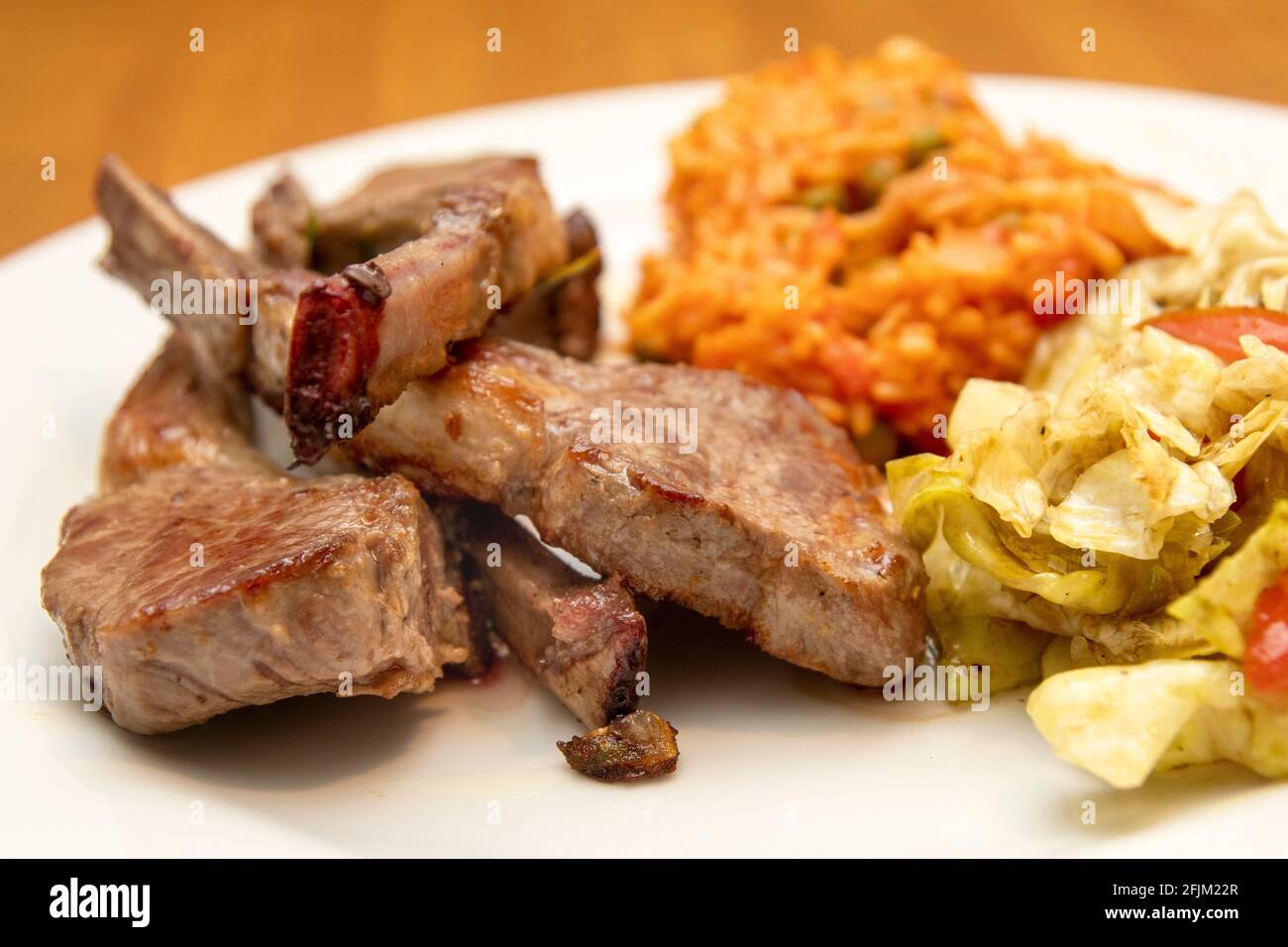 lamb chops with djuvec rice and salad Stock Photo - Alamy