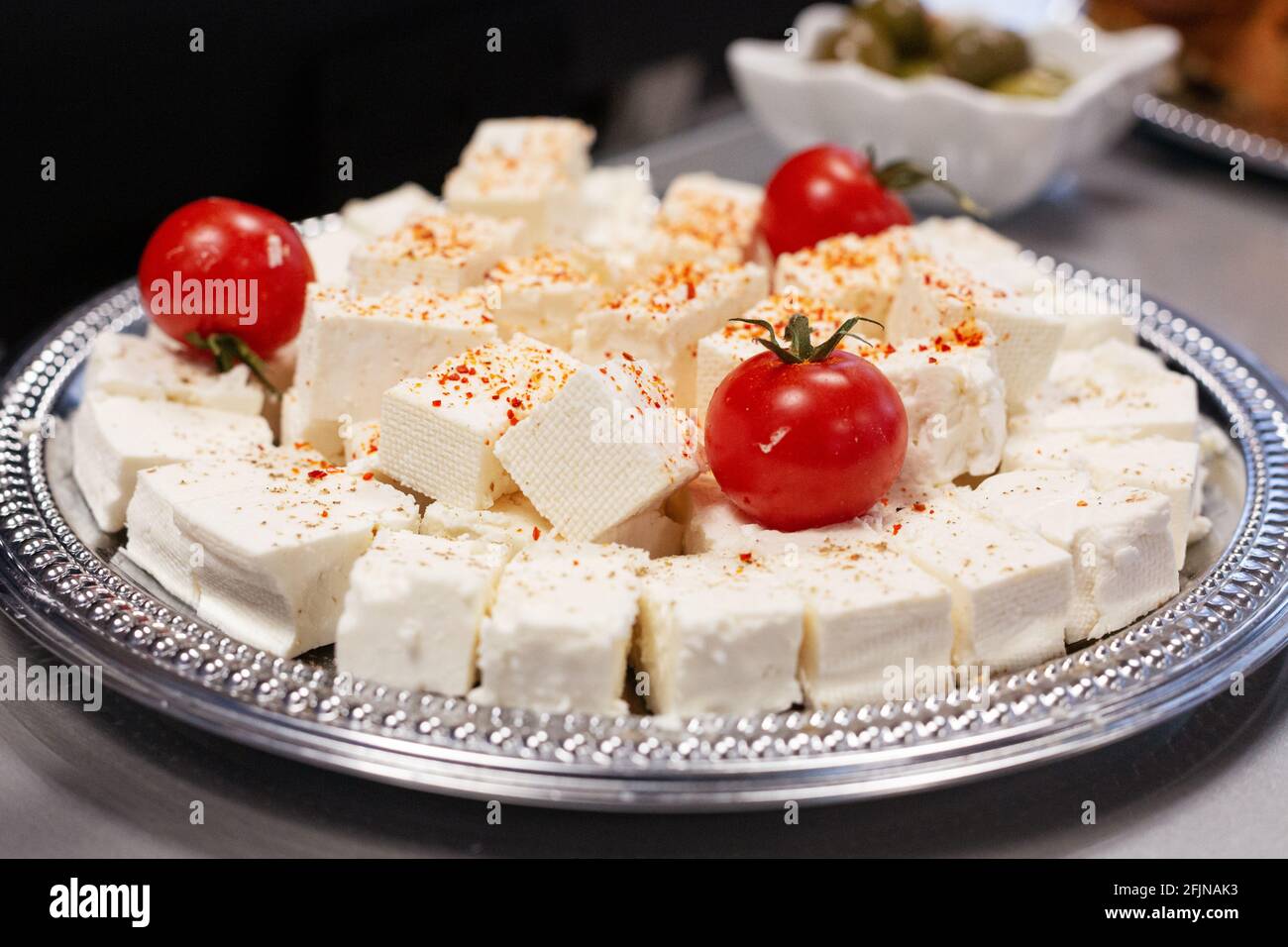 Fresh white feta cheese with cherry tomatoes on serving plate Stock ...