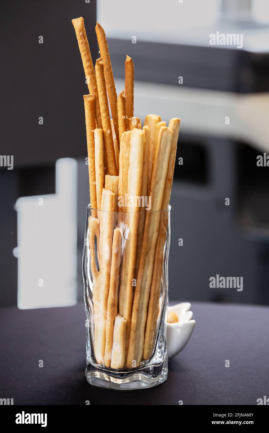 Bread sticks in clear glass at the office table Stock Photo - Alamy