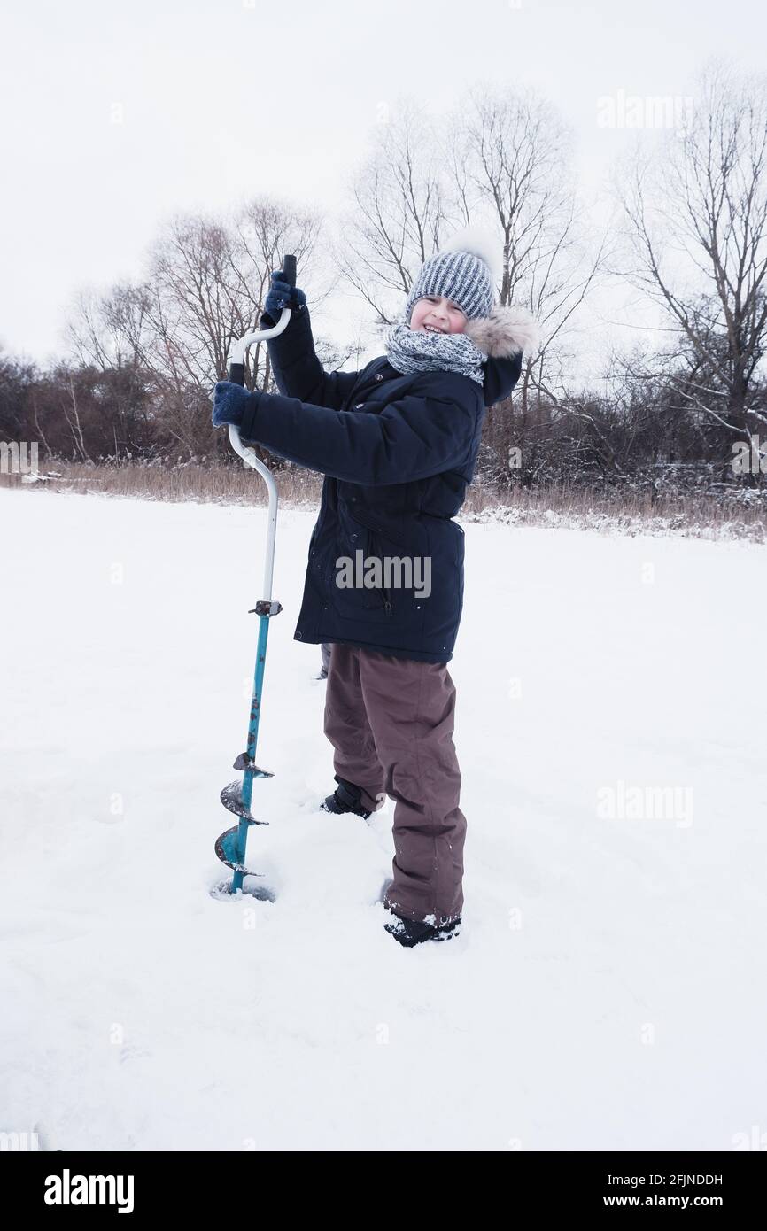 Children on ice fishing pose for the camera Stock Photo - Alamy