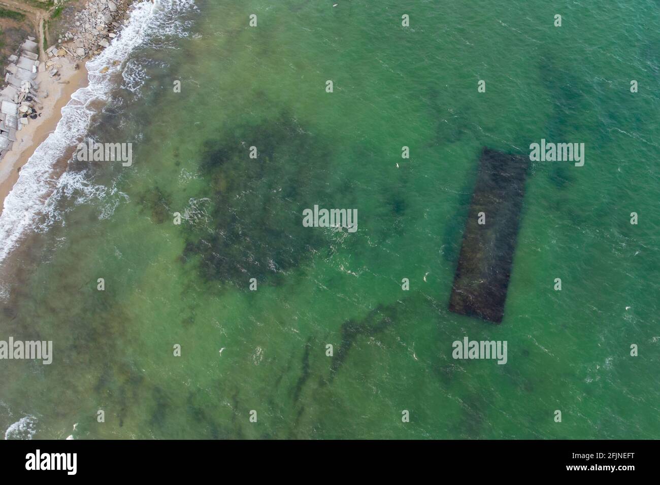 Aerial view of a sunken cargo container near the seashore Stock Photo ...