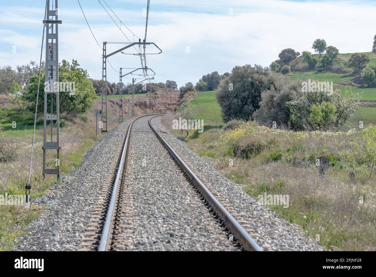 View of railroad rails with rails, catenary and crossbeams Stock Photo ...