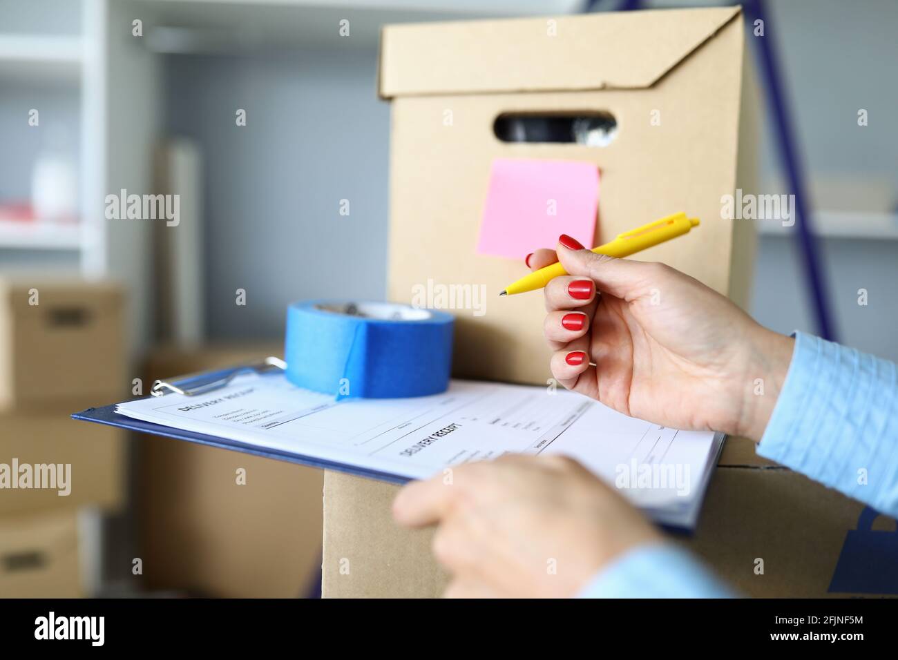 Woman signs documents for the delivery of parcels Stock Photo - Alamy