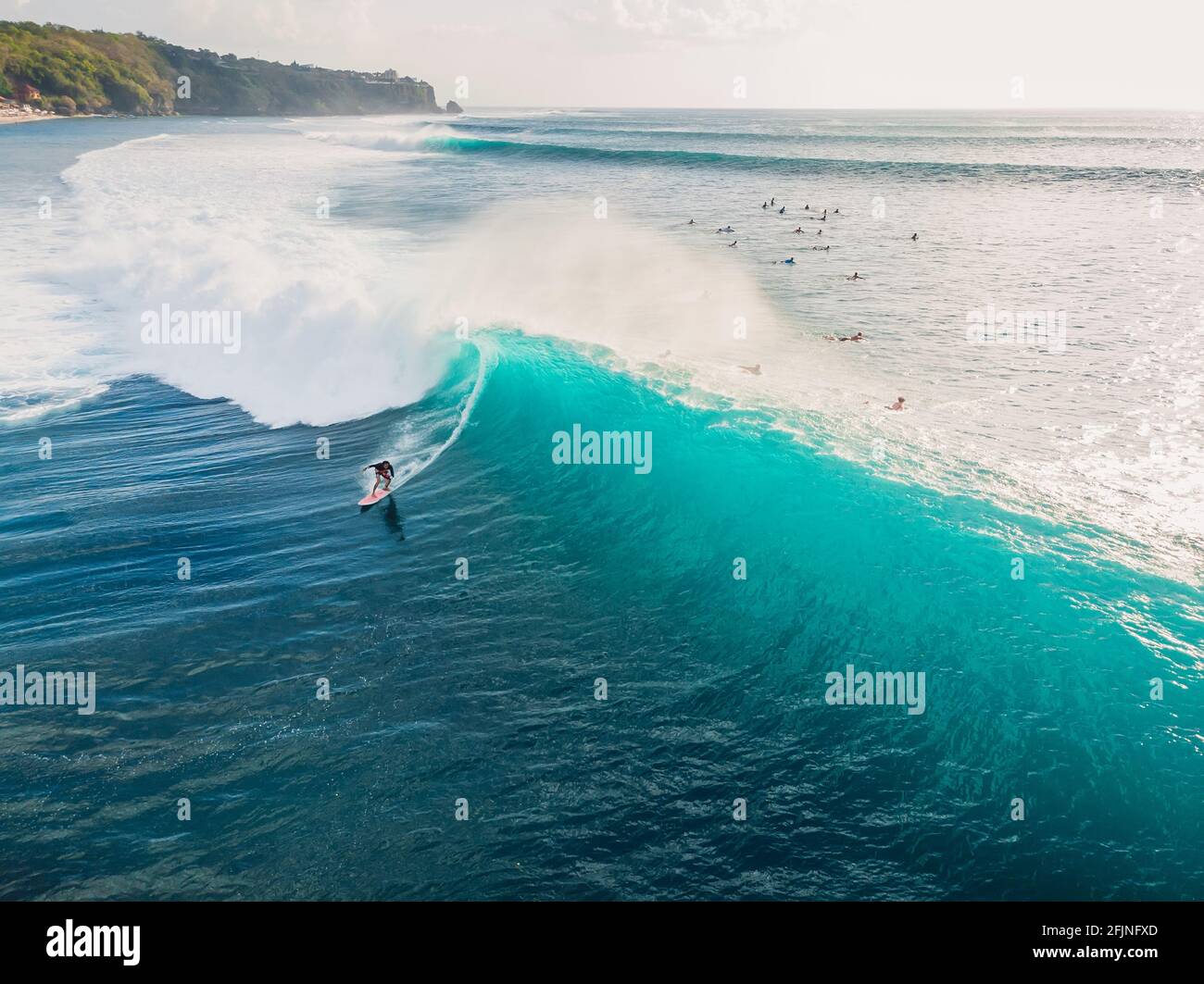 Aerial view with surfing on ideal barrel wave. Blue perfect waves and ...