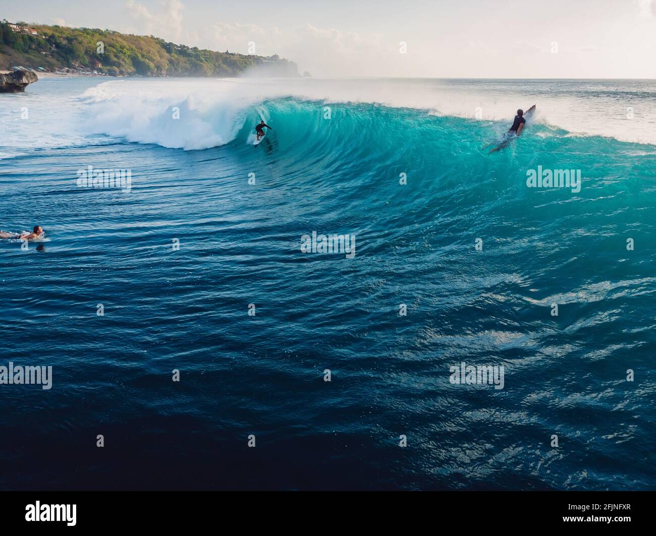 Aerial view with surfing on ideal barrel wave. Blue perfect waves and ...