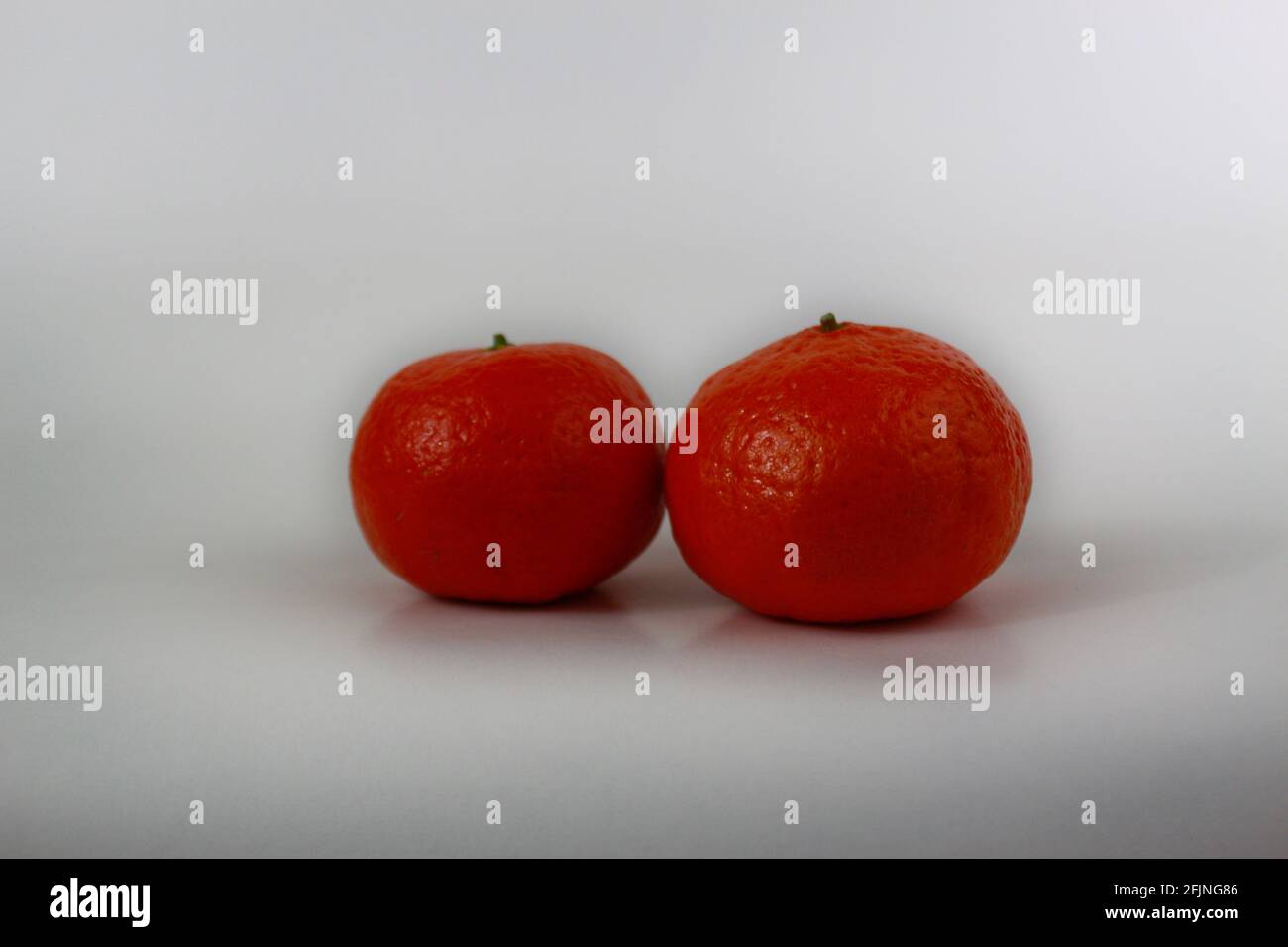 Two tangerine isolated on white background Stock Photo - Alamy