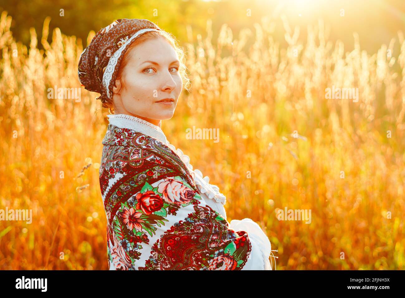 Young beautiful slovak woman in traditional costume on summer daisy ...