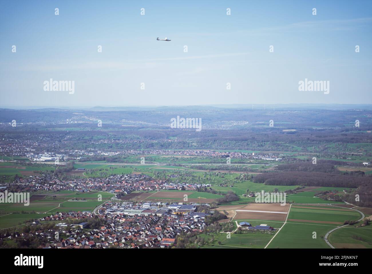glider flys over a valley in Germany, near Stuttgart. View from a cliff ...