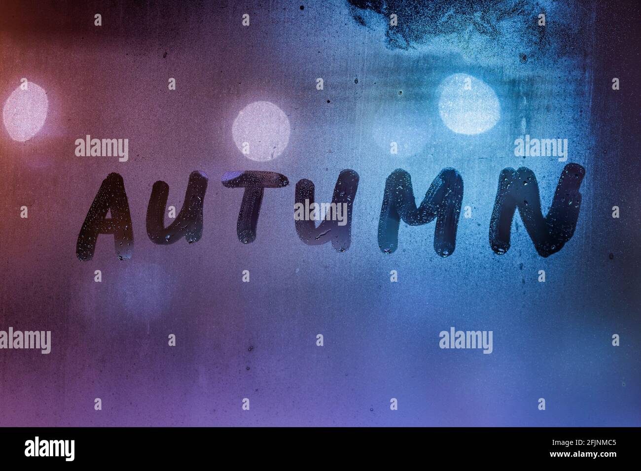 the word autumn handwritten on night wet window glass surface Stock ...