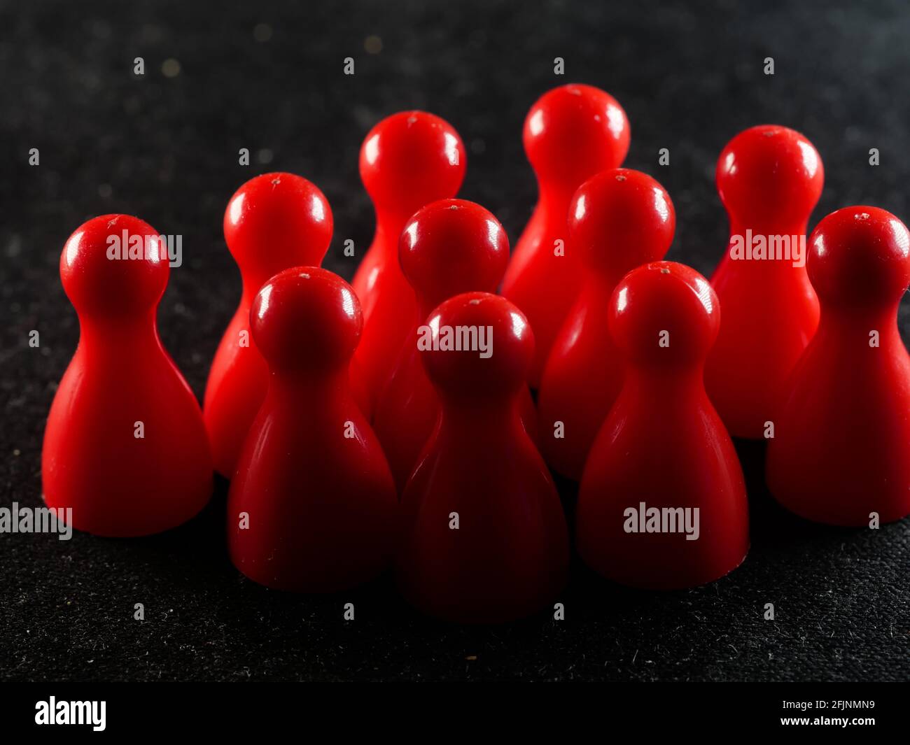 A studio shot of red monopoly plastic chips on black background Stock ...