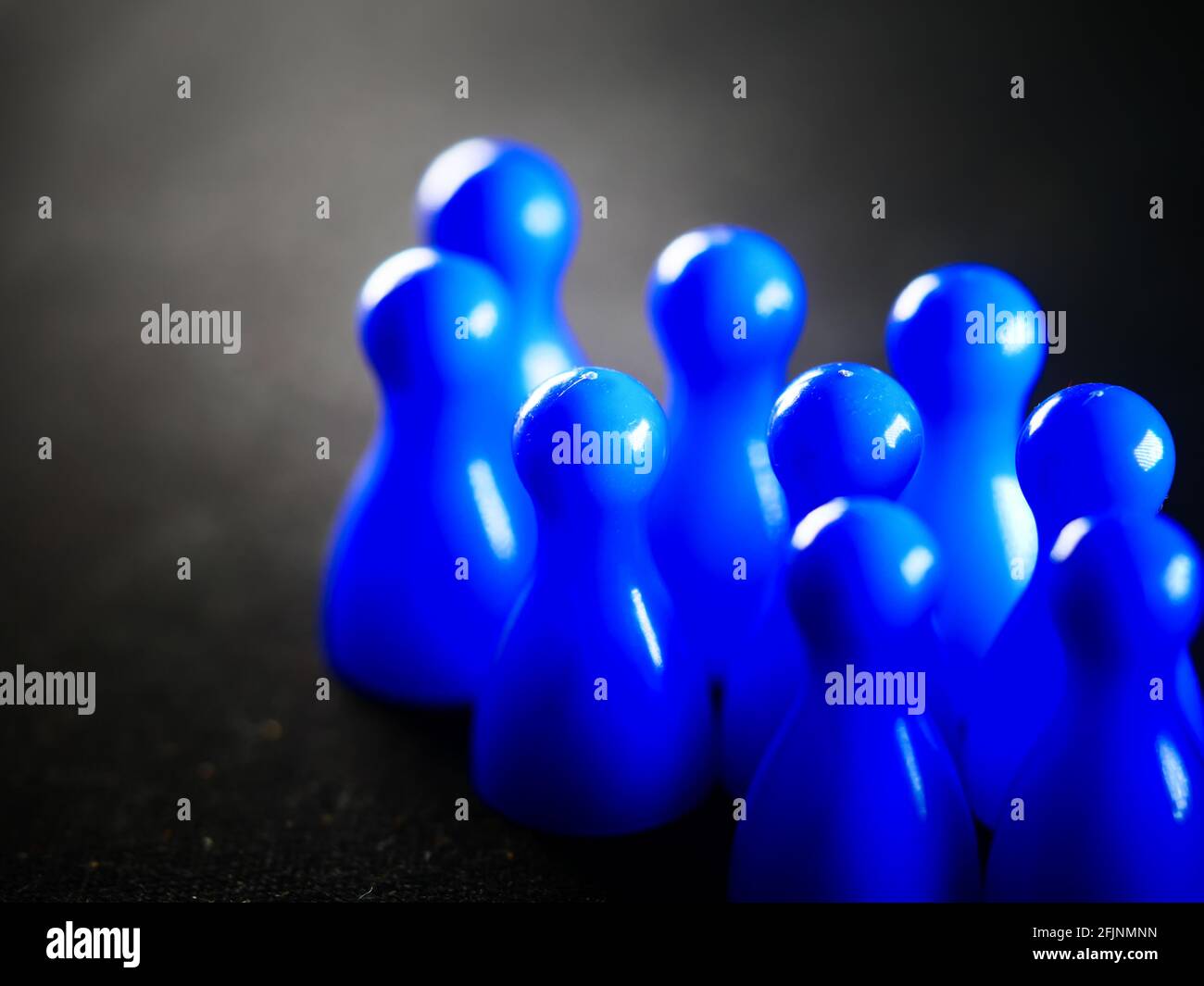 A studio shot of blue monopoly plastic chips on black background Stock ...