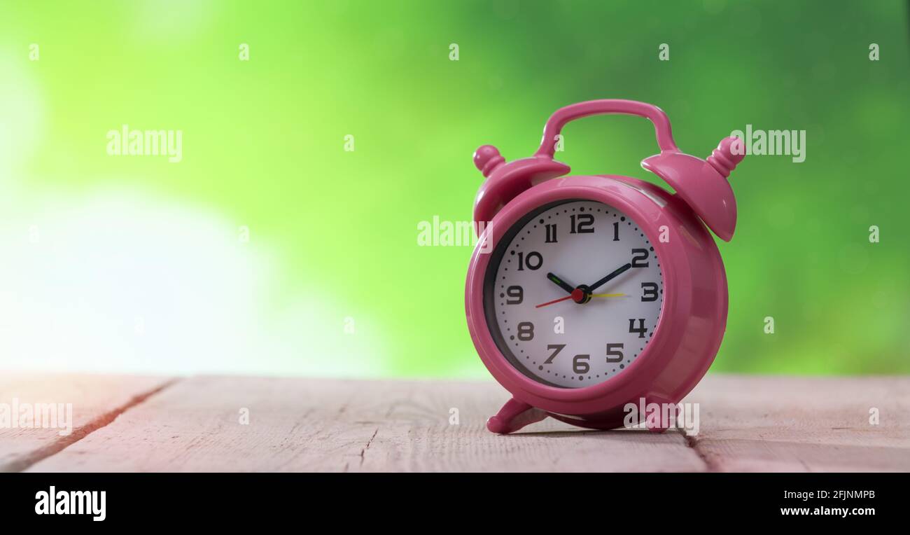 Pink Table Clock on the Desk at Sunrise Stock Photo - Alamy