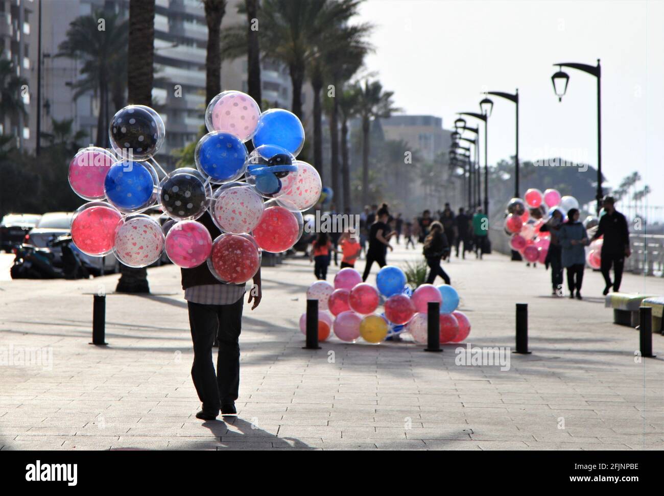 Beruit, Lebanon. 24th Apr, 2021. A balloon vendor walks along the ...