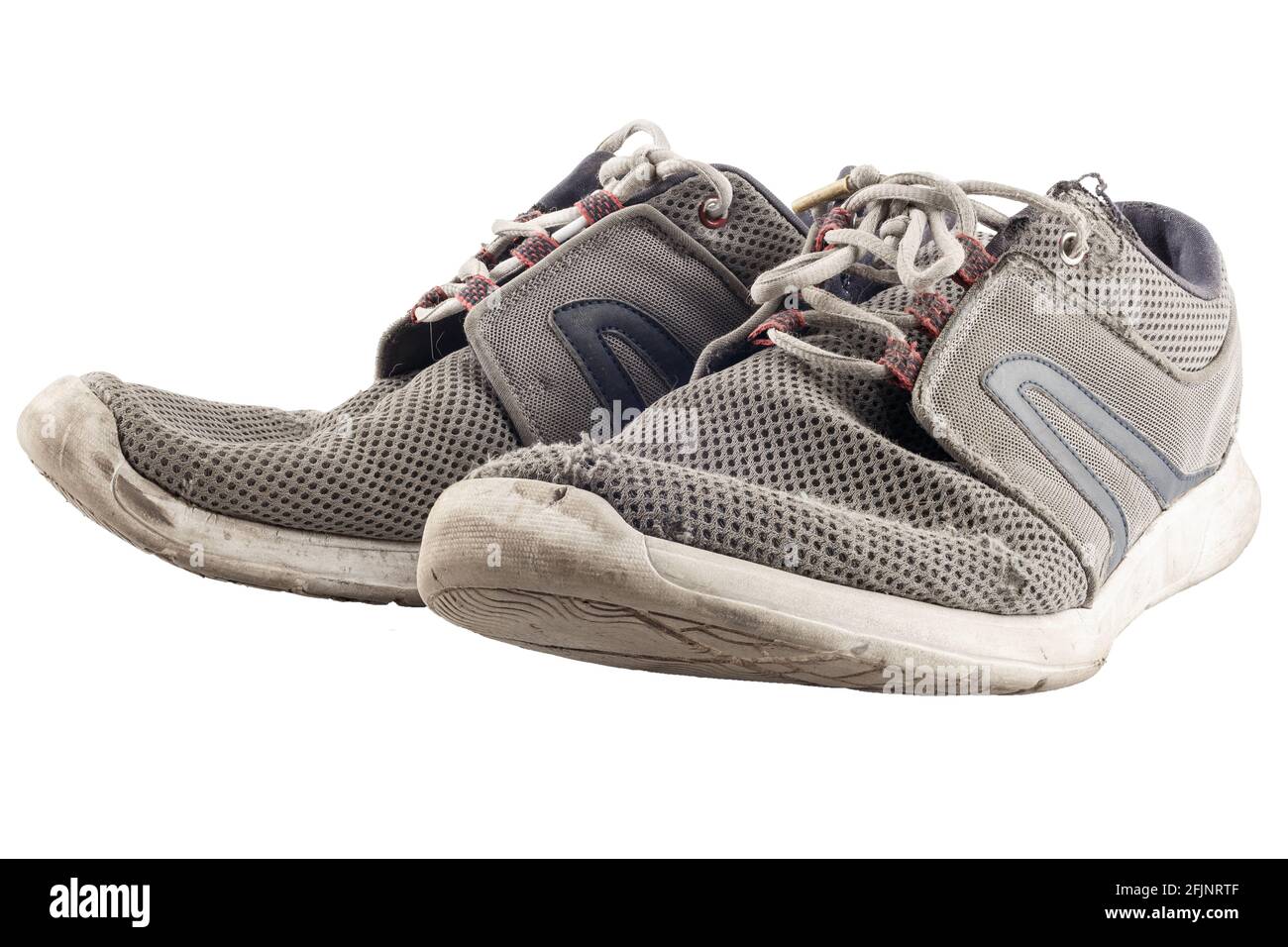 pair of worn out sneakers isolated on white background Stock Photo - Alamy