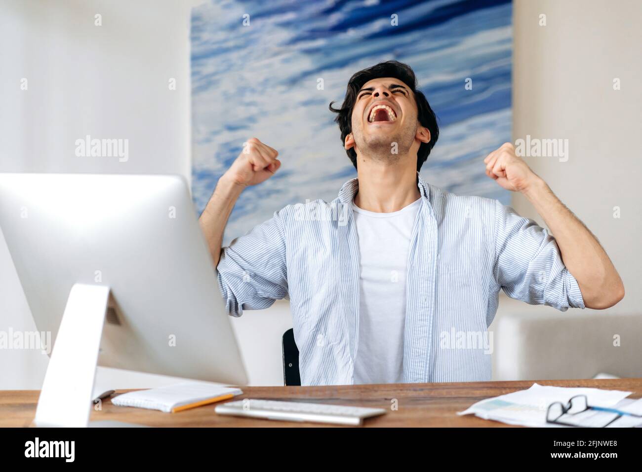 Hispanic man shouting happily hi-res stock photography and images - Alamy