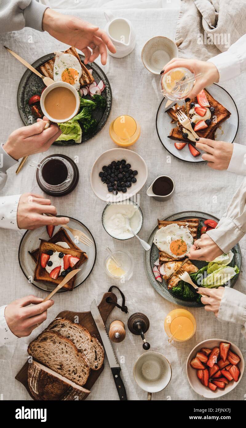 People having brunch together and talking, top view Stock Photo - Alamy