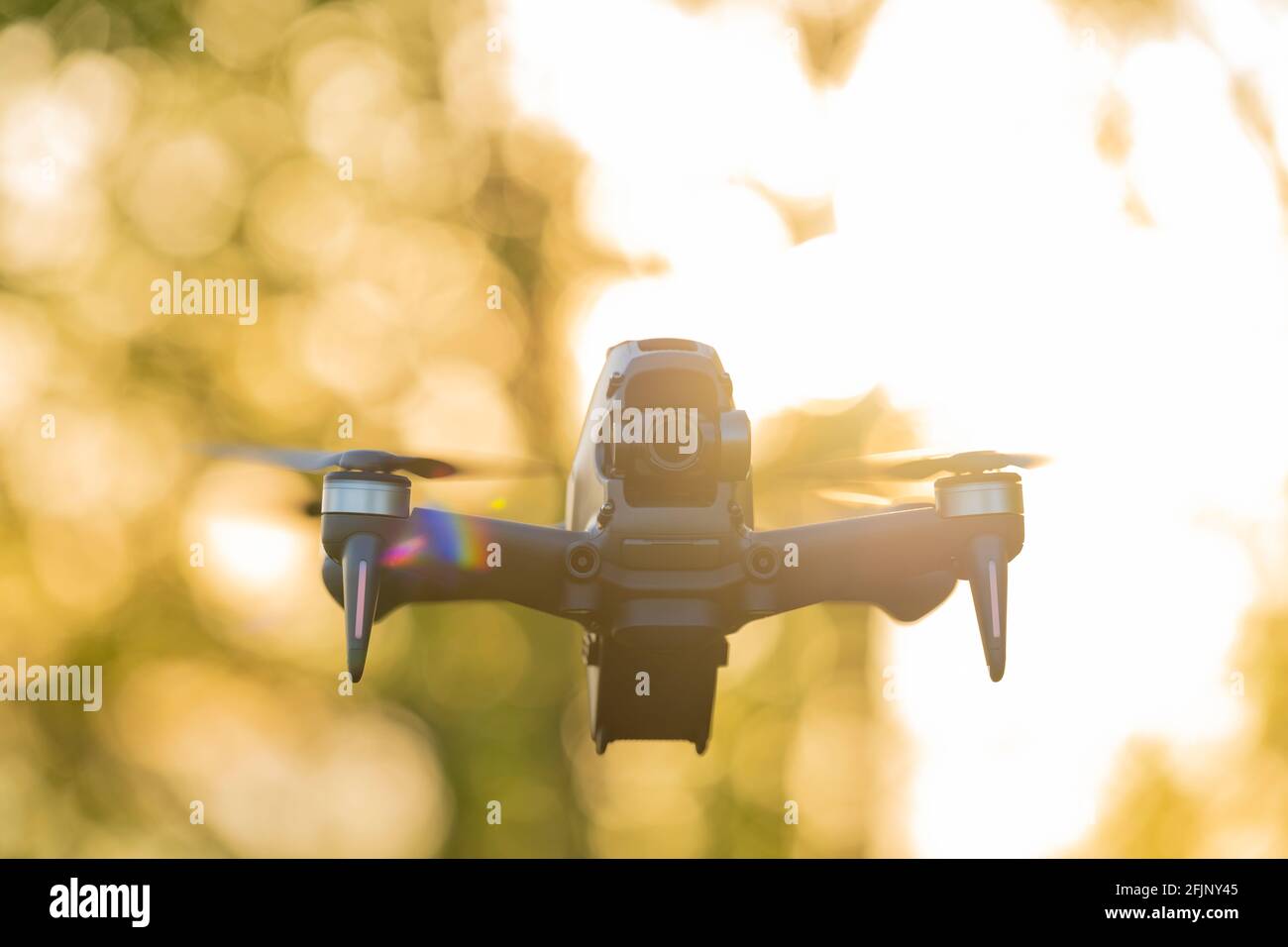 Stunning view of an FPV drone flying over a grass field during a ...