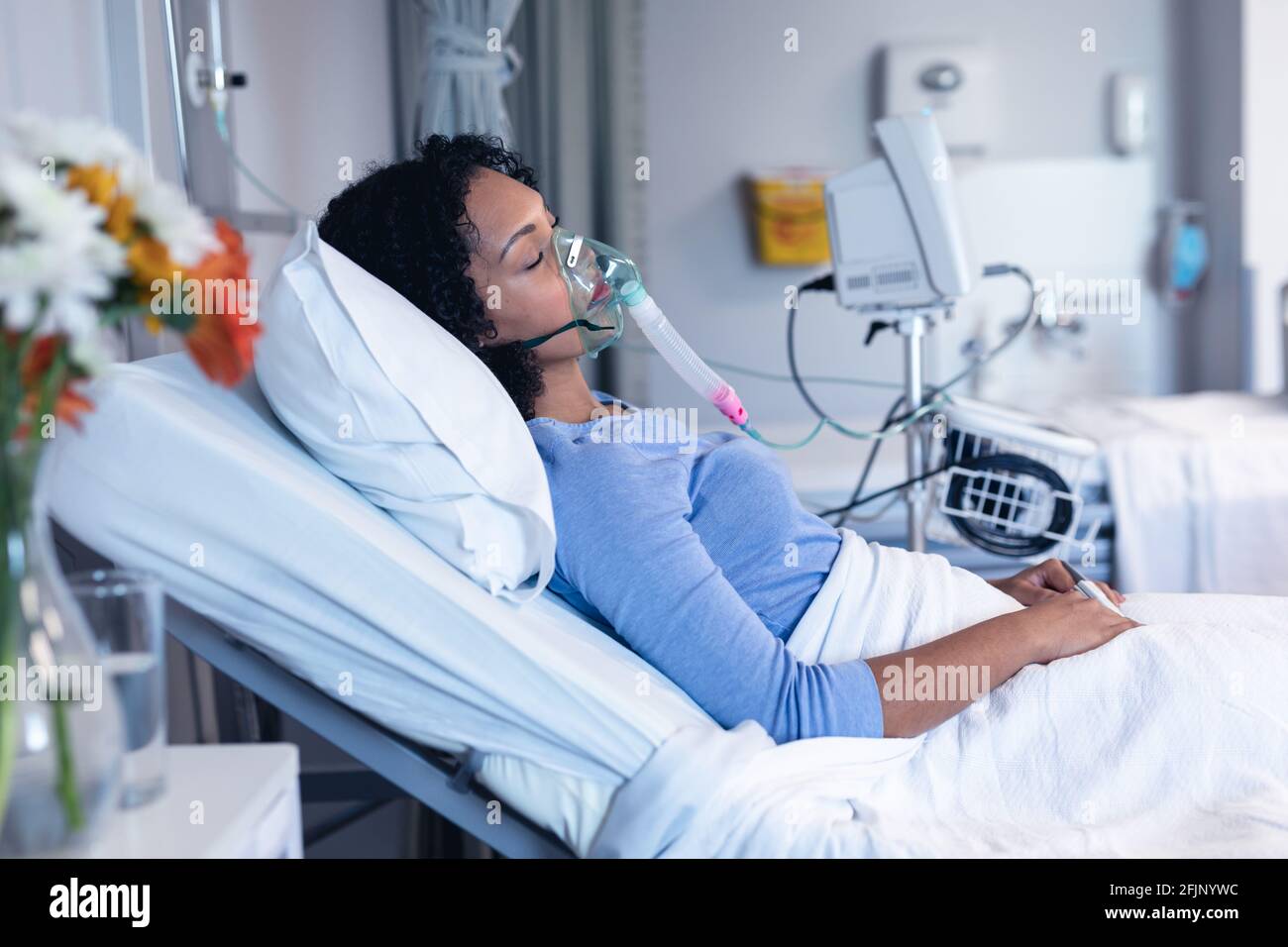 Sleeping african american female patient in hospital bed with oxygen ...