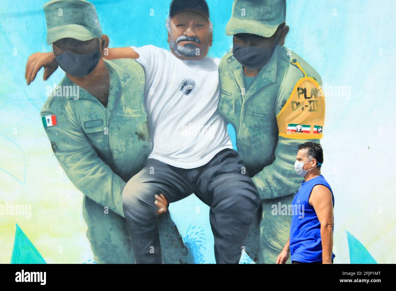 Man passing in front of a mural portraying the Covid-19 first ...