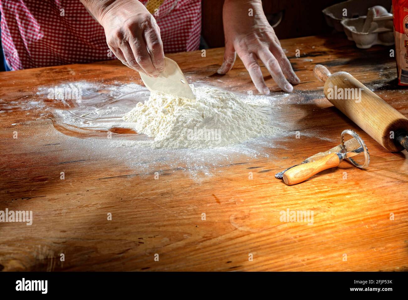 Flour with eggs on wooden table, Germany, Germany Stock Photo - Alamy