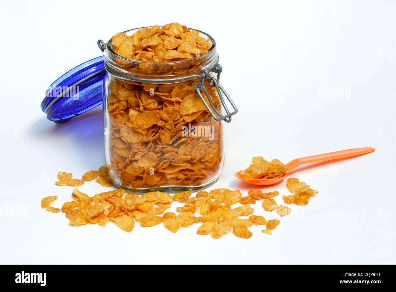 Glass jar with cornflakes, spoon, preserving jar Stock Photo - Alamy