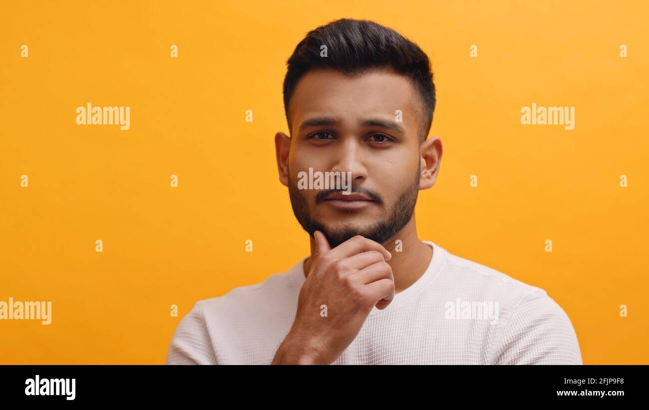 Portrait of handsome adult man touching his chin and looking up. Mixed ...