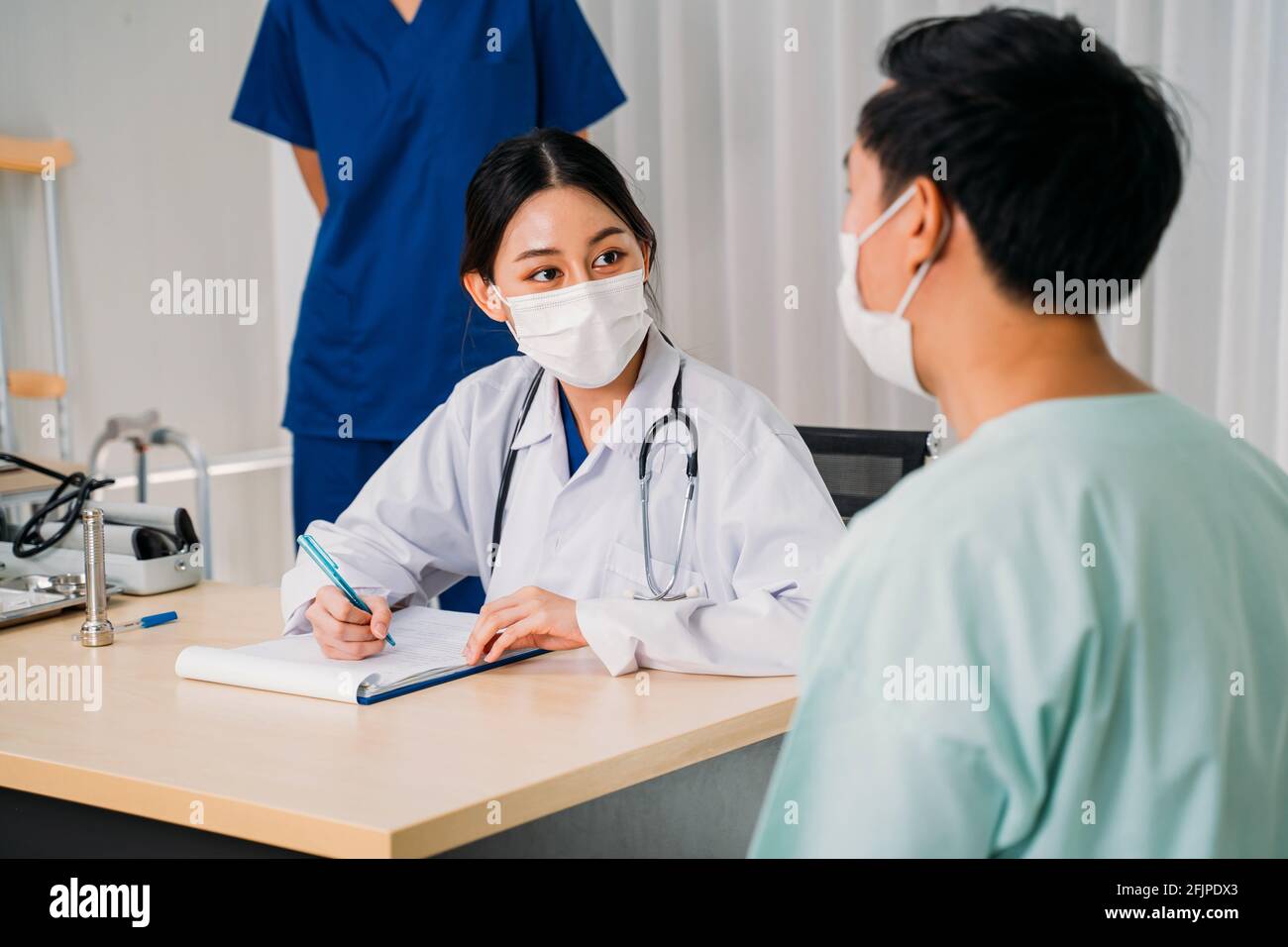 Female asian doctor writing hi-res stock photography and images - Alamy
