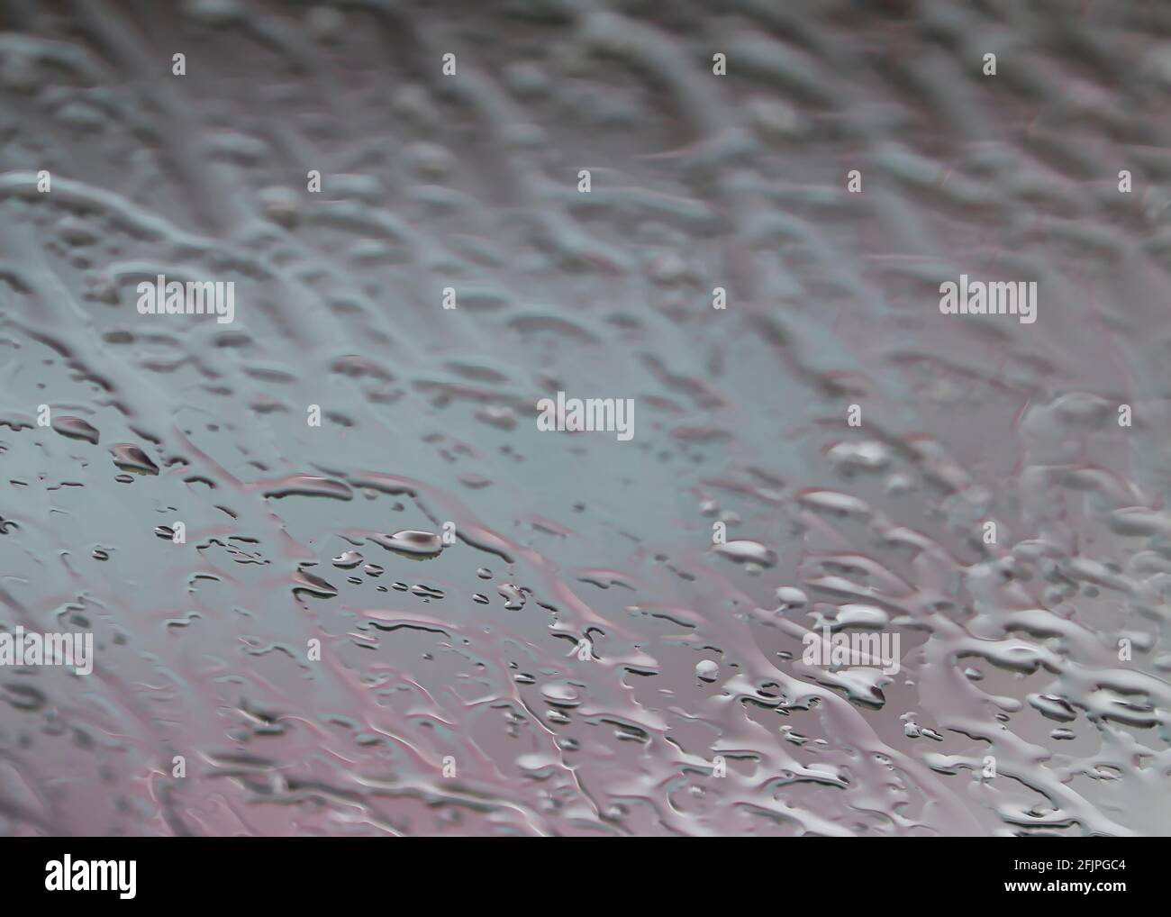 dim gray day seen through window of car with water splash Stock Photo ...