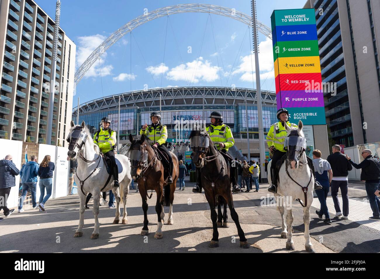 London, Britain. 25th Apr, 2021. Mounted police officers watch football ...