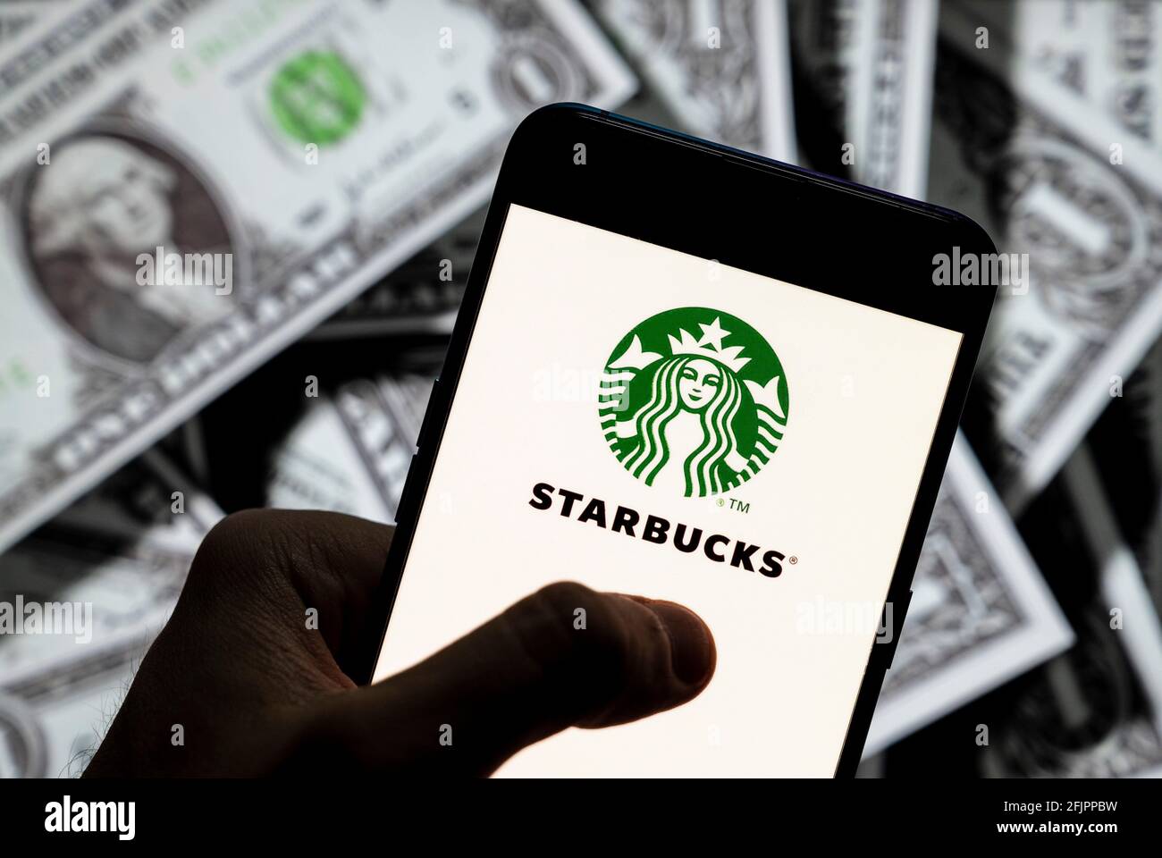In this photo illustration, a Starbucks Coffee logo seen displayed on a ...