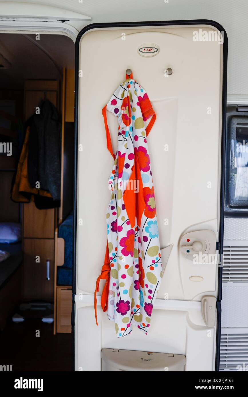Fehmarn, Germany. 20th Apr, 2021. A cooking apron hangs on the door of ...
