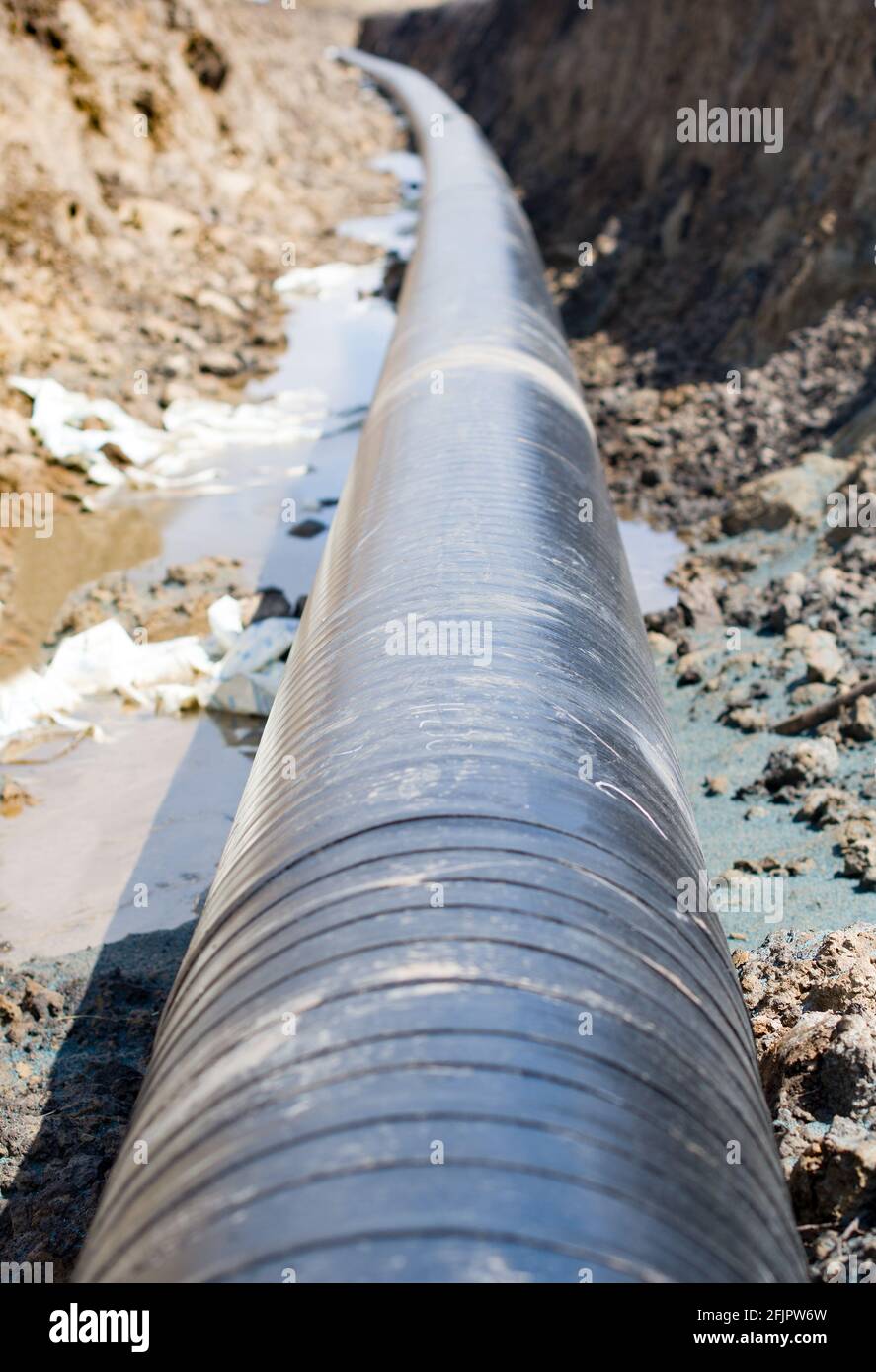 Natural gas pipeline construction work. A dug trench in the ground for ...