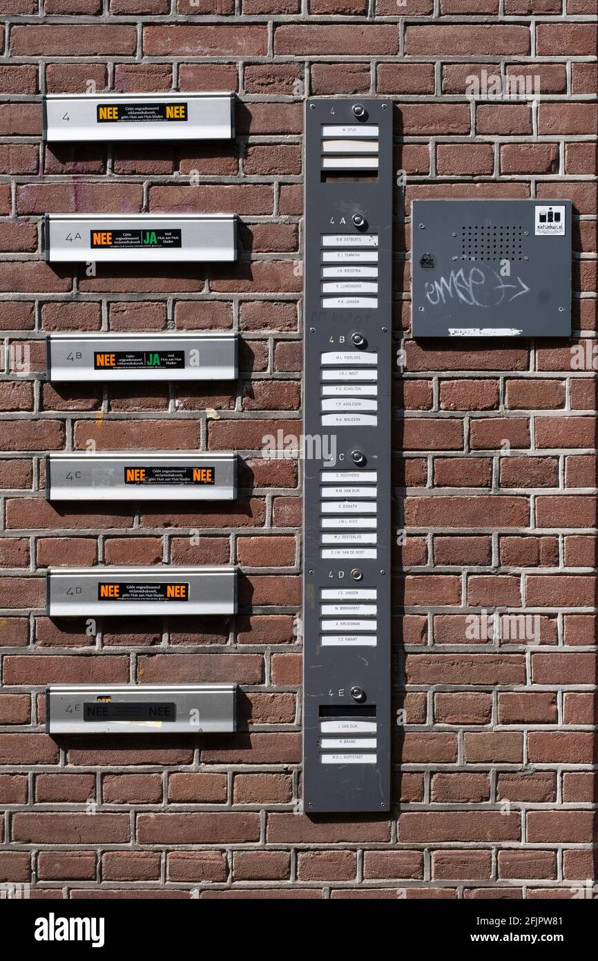 Vertical row of mailboxes, doorbells and intercom for residents in an ...