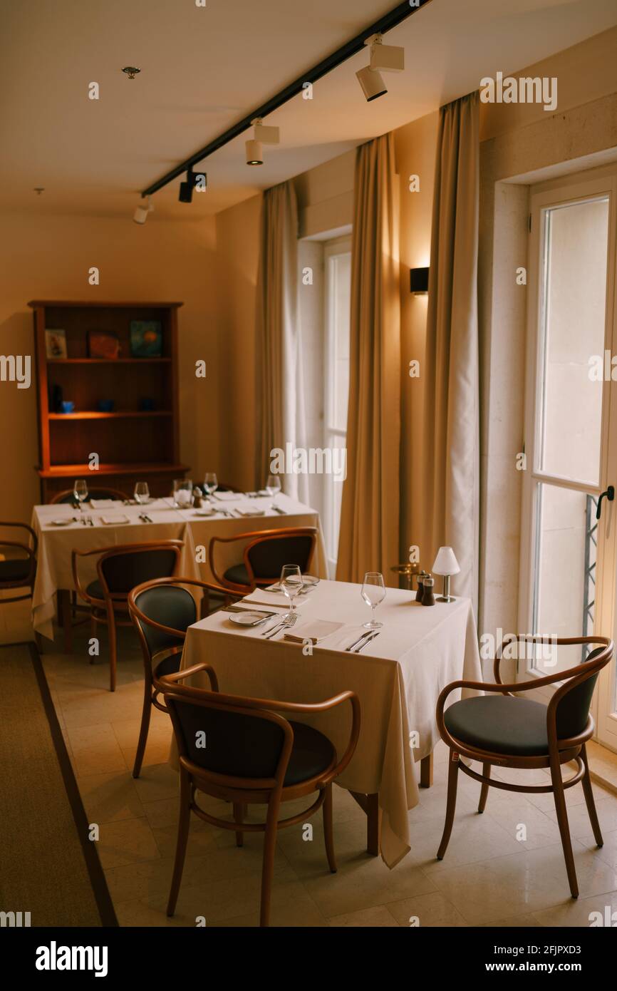 Cozy classic interior of the restaurant, tables are by the window Stock ...