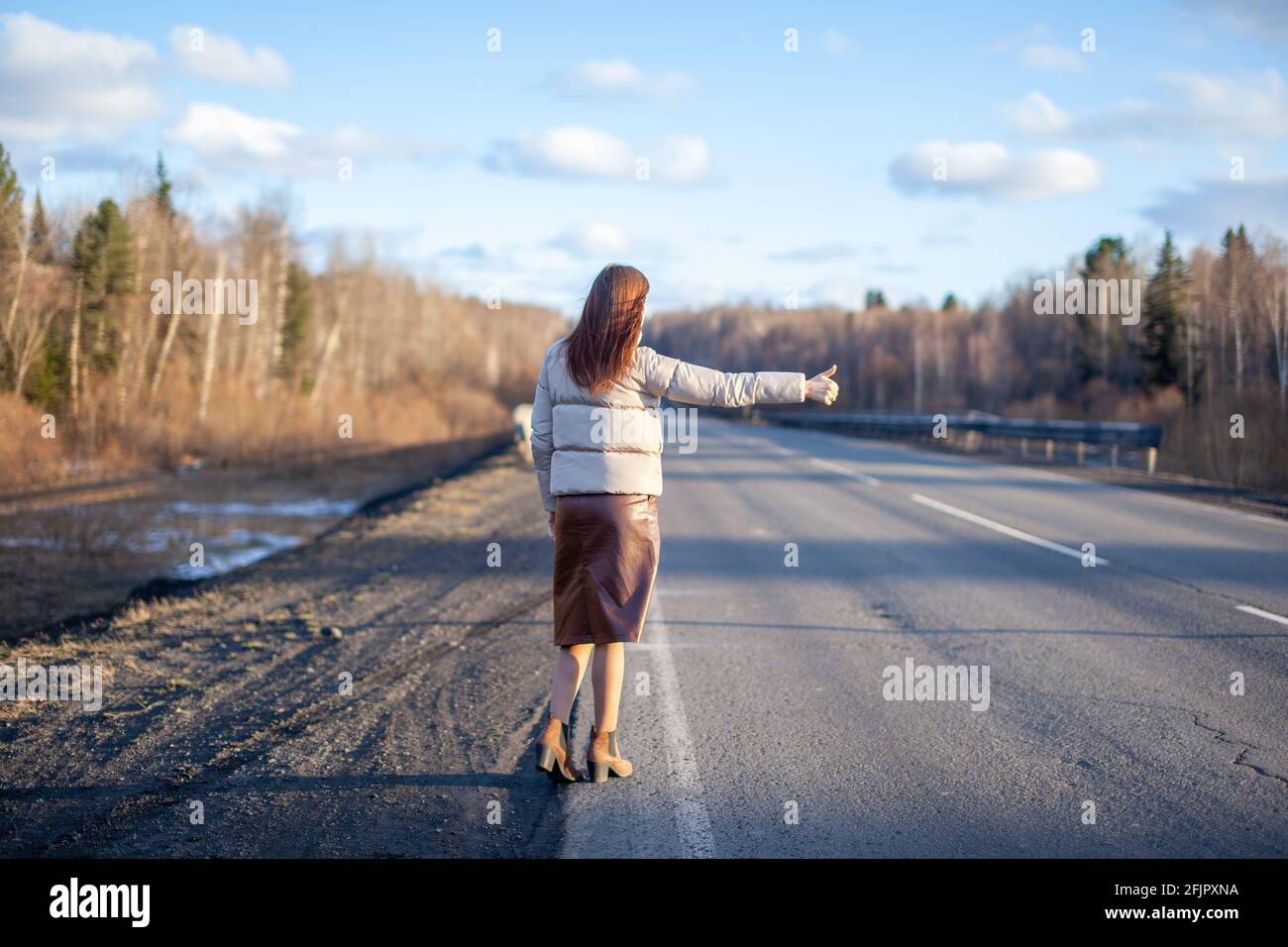 The girl stops the car on the highway with her hand Stock Photo - Alamy