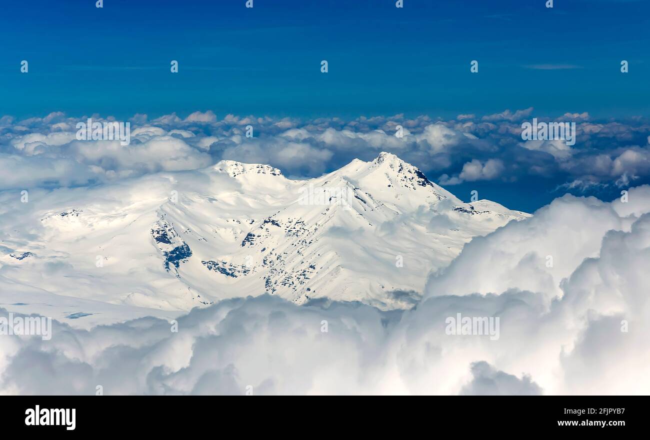Aerial view of the mountain ranges. View through clouds at mountain ...