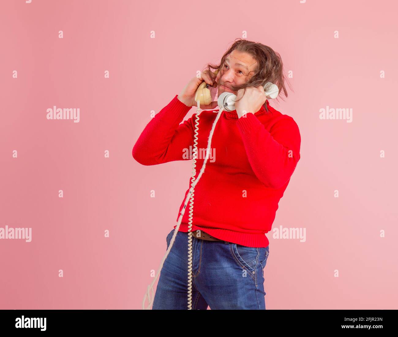 Adult male call center worker in casual clothes answers phone calls ...