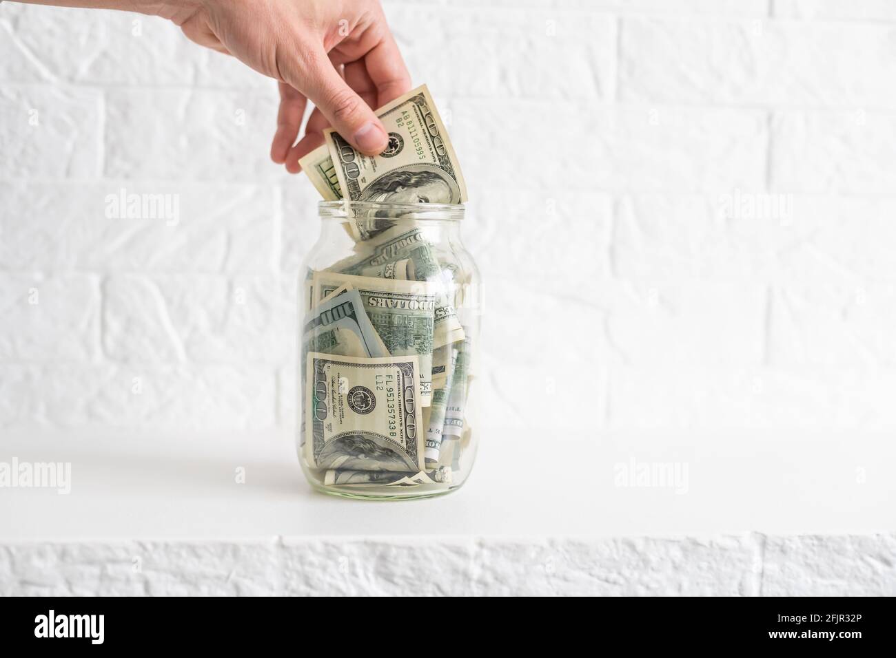 100 dollar bills jar hi-res stock photography and images - Alamy